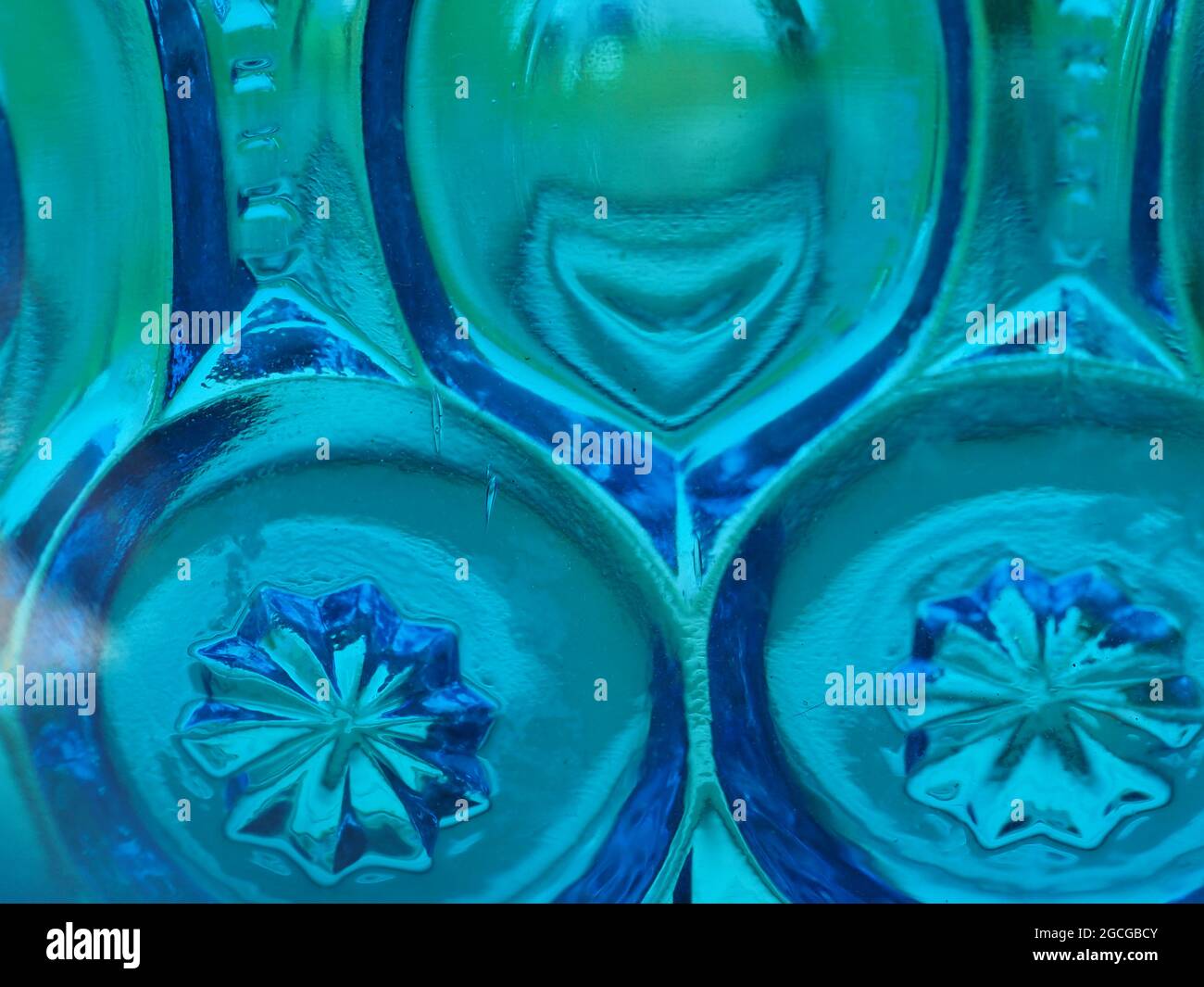 A close up photograph of Blue Carnival Glass pattern Stock Photo - Alamy