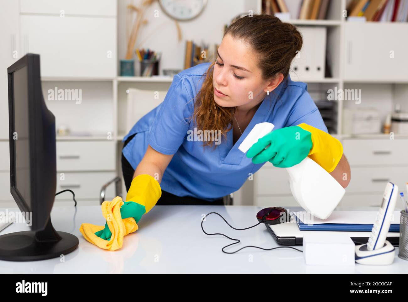 Young friendly cleaning woman in work uniform Stock Photo - Alamy