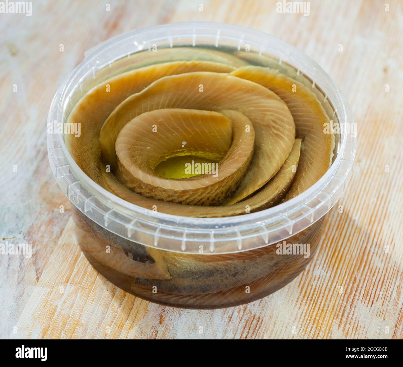 Plastic container with preserved herring fillet Stock Photo - Alamy