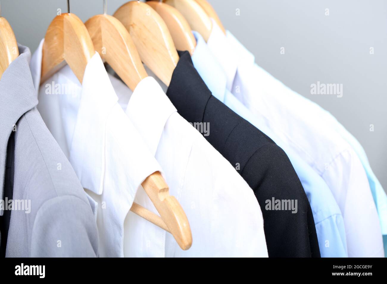 Clothes on circle hanger on light background Stock Photo - Alamy