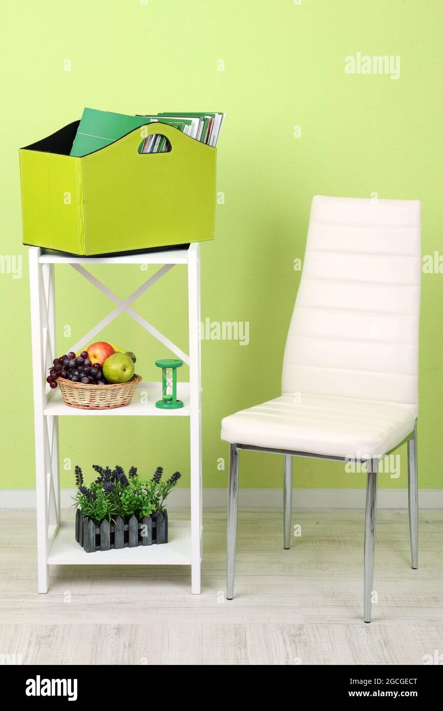 Magazines and folders in green box on shelf in room Stock Photo - Alamy