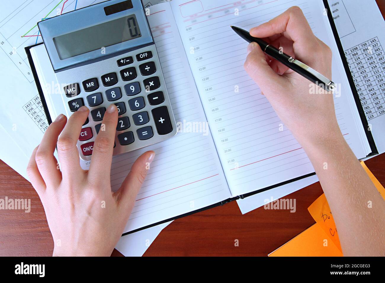 Woman hands counting on calculator on worktable background Stock Photo ...