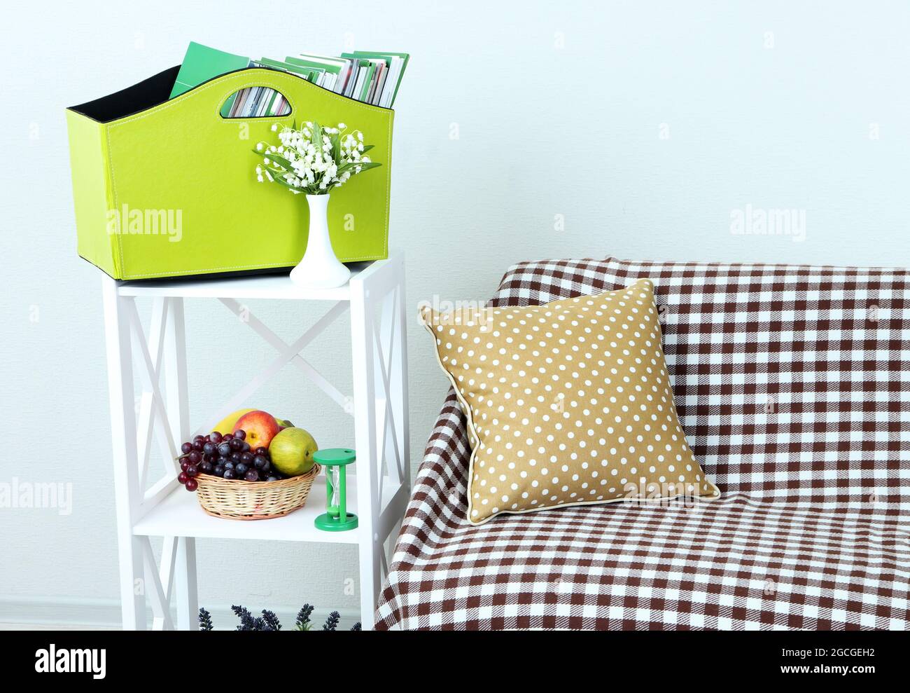 Magazines and folders in green box on shelf in room Stock Photo - Alamy