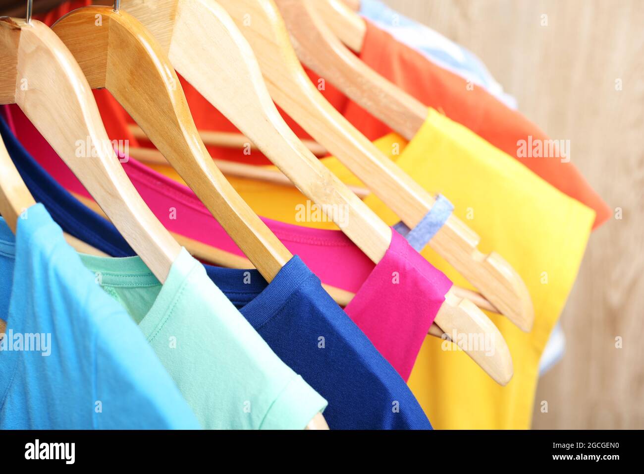 Clothes on circle hanger on light background Stock Photo - Alamy