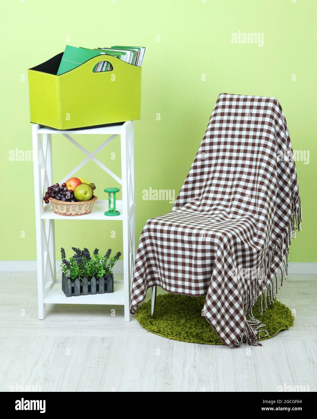 Magazines and folders in green box on shelf in room Stock Photo - Alamy