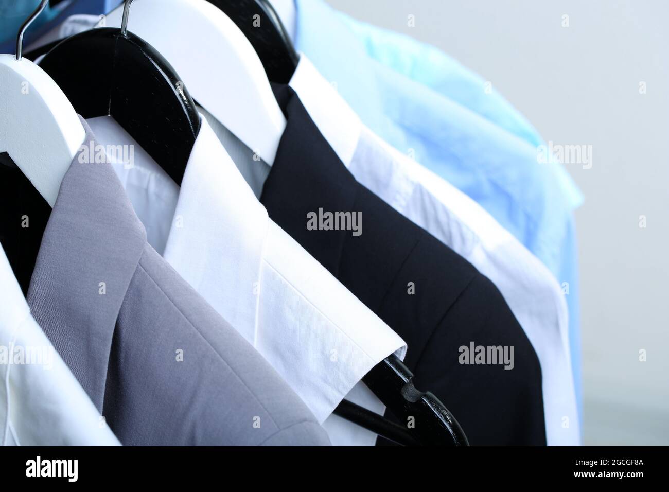 Clothes on circle hanger on light background Stock Photo - Alamy