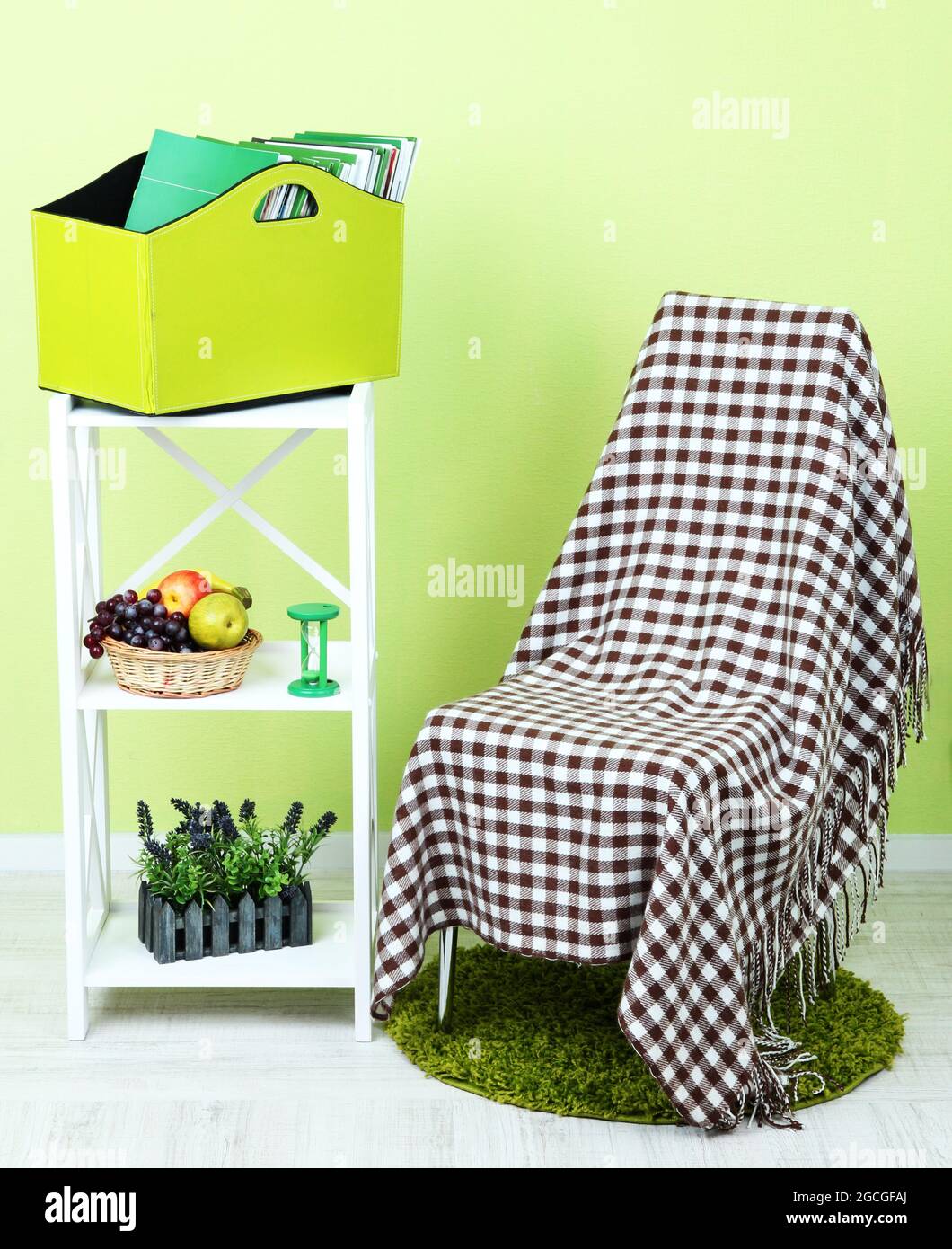 Magazines and folders in green box on shelf in room Stock Photo - Alamy