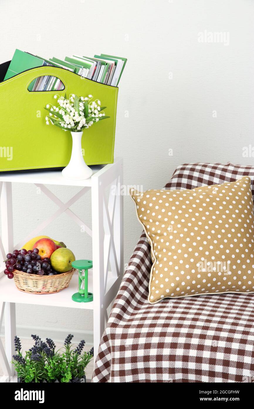 Magazines and folders in green box on shelf in room Stock Photo - Alamy