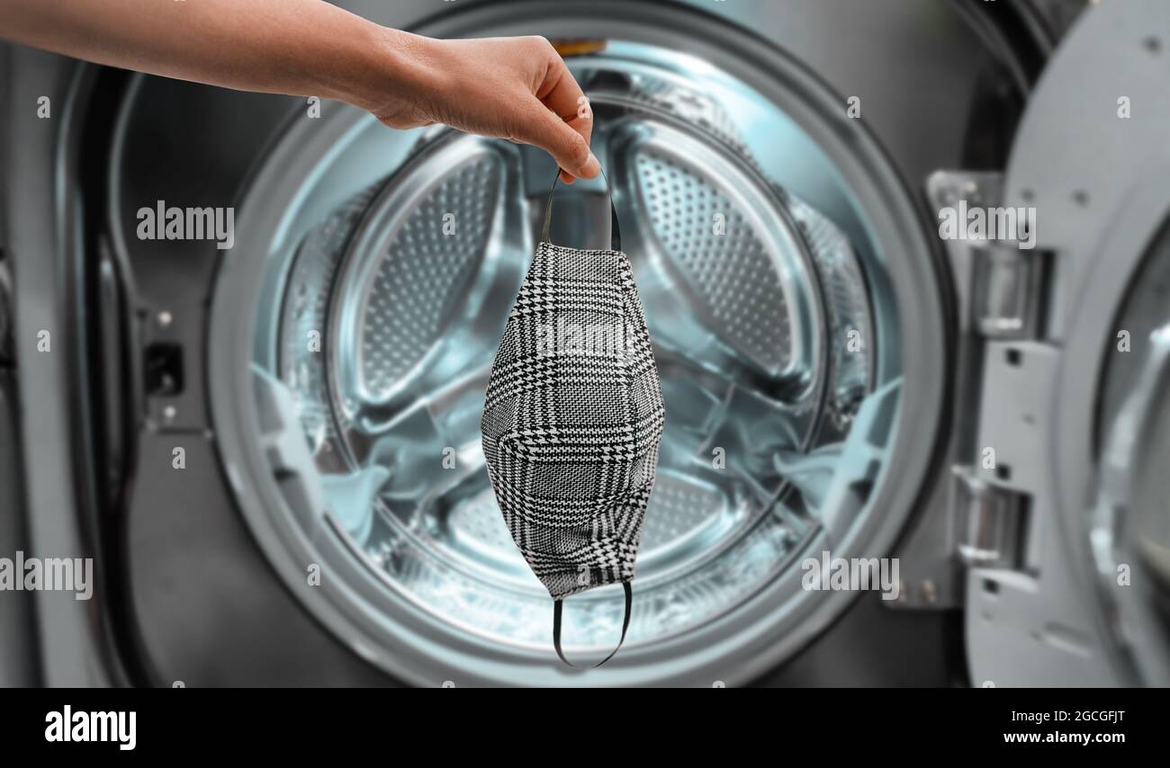 Putting the face mask in the washing machine with dirty laundry. Keep ...