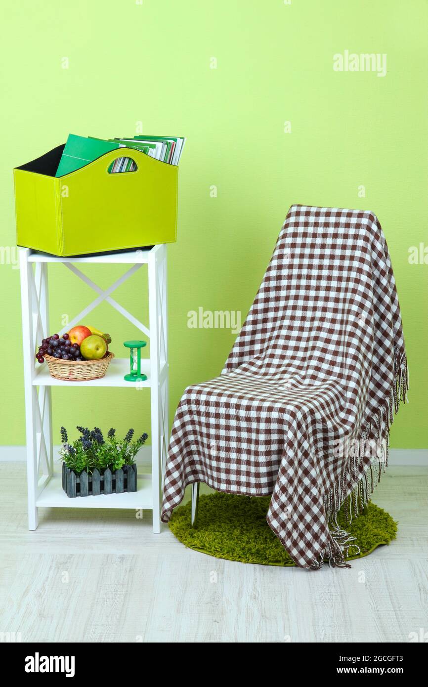 Magazines and folders in green box on shelf in room Stock Photo - Alamy