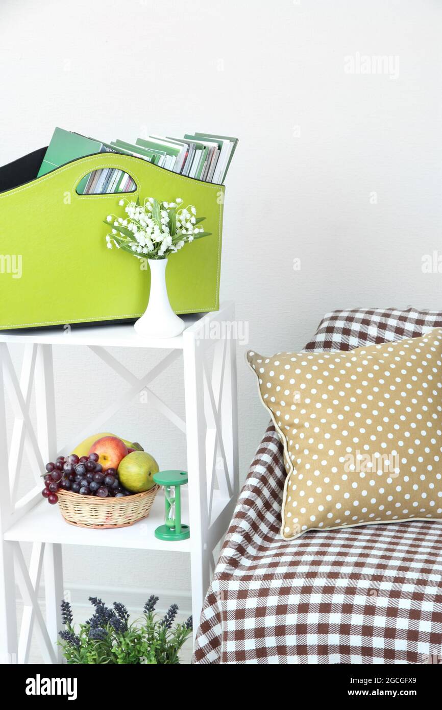 Magazines and folders in green box on shelf in room Stock Photo - Alamy