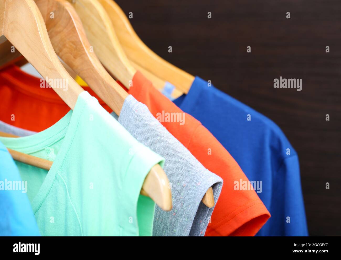 Clothes on circle hanger on dark background Stock Photo - Alamy
