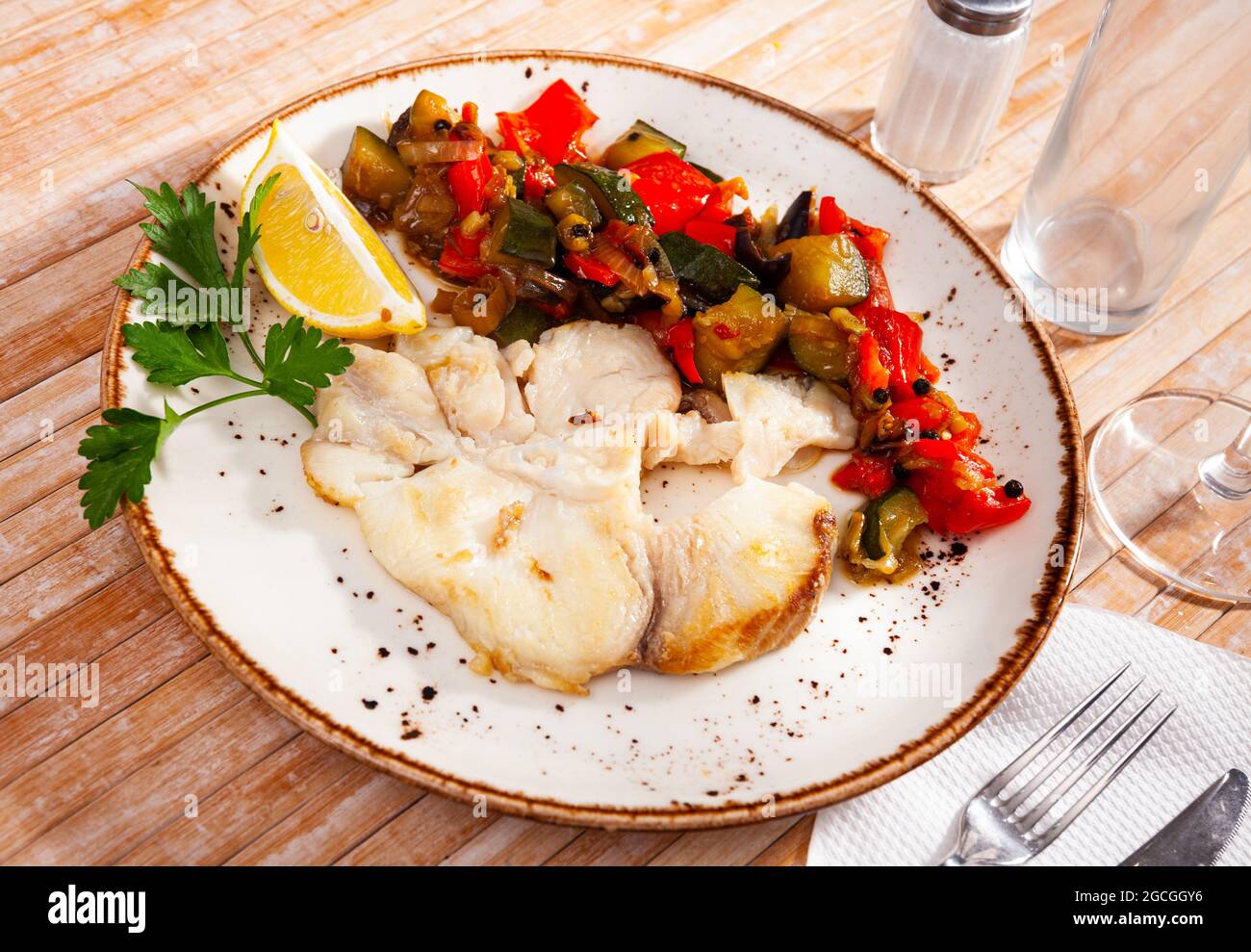 Roasted blue shark steak with vegetable saute, lemon and greens Stock ...