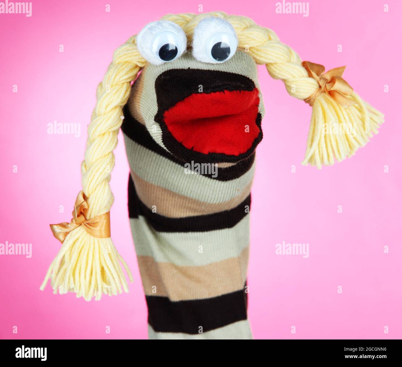 Cute sock puppet on pink background Stock Photo - Alamy