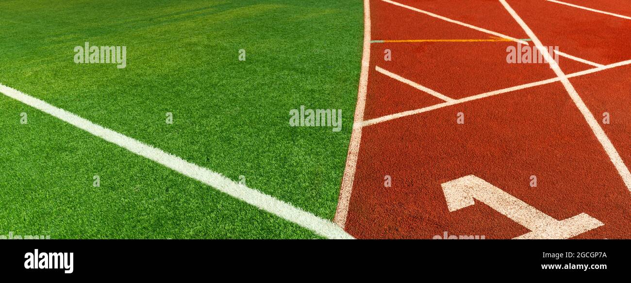 green artificial football field and red brown running tract sport filed ...
