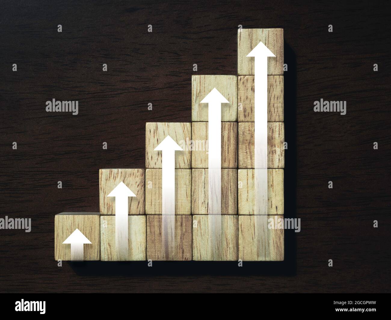 Rising up arrows on wooden blocks chart steps on dark wood background ...