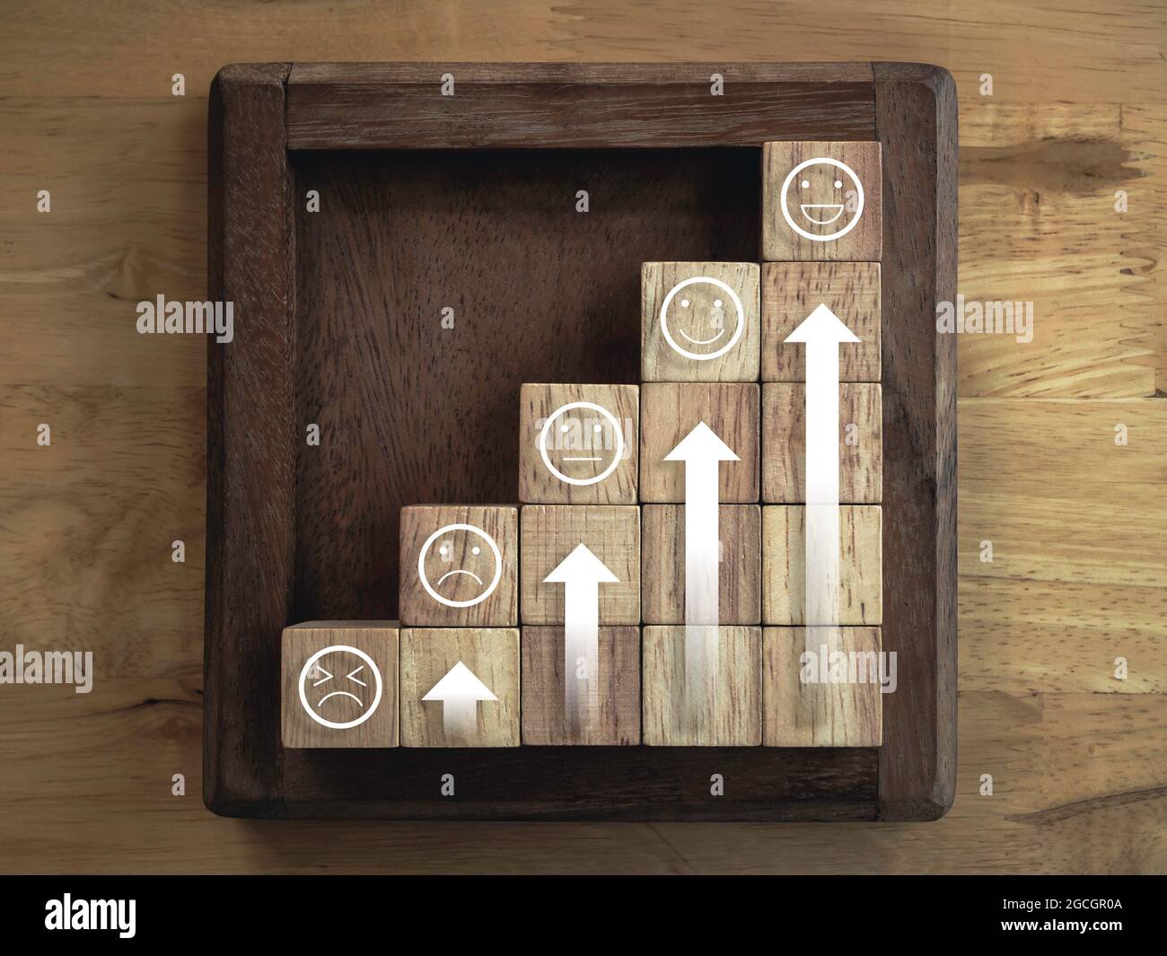 Rising up arrows on wooden blocks chart steps with face emotion icons ...