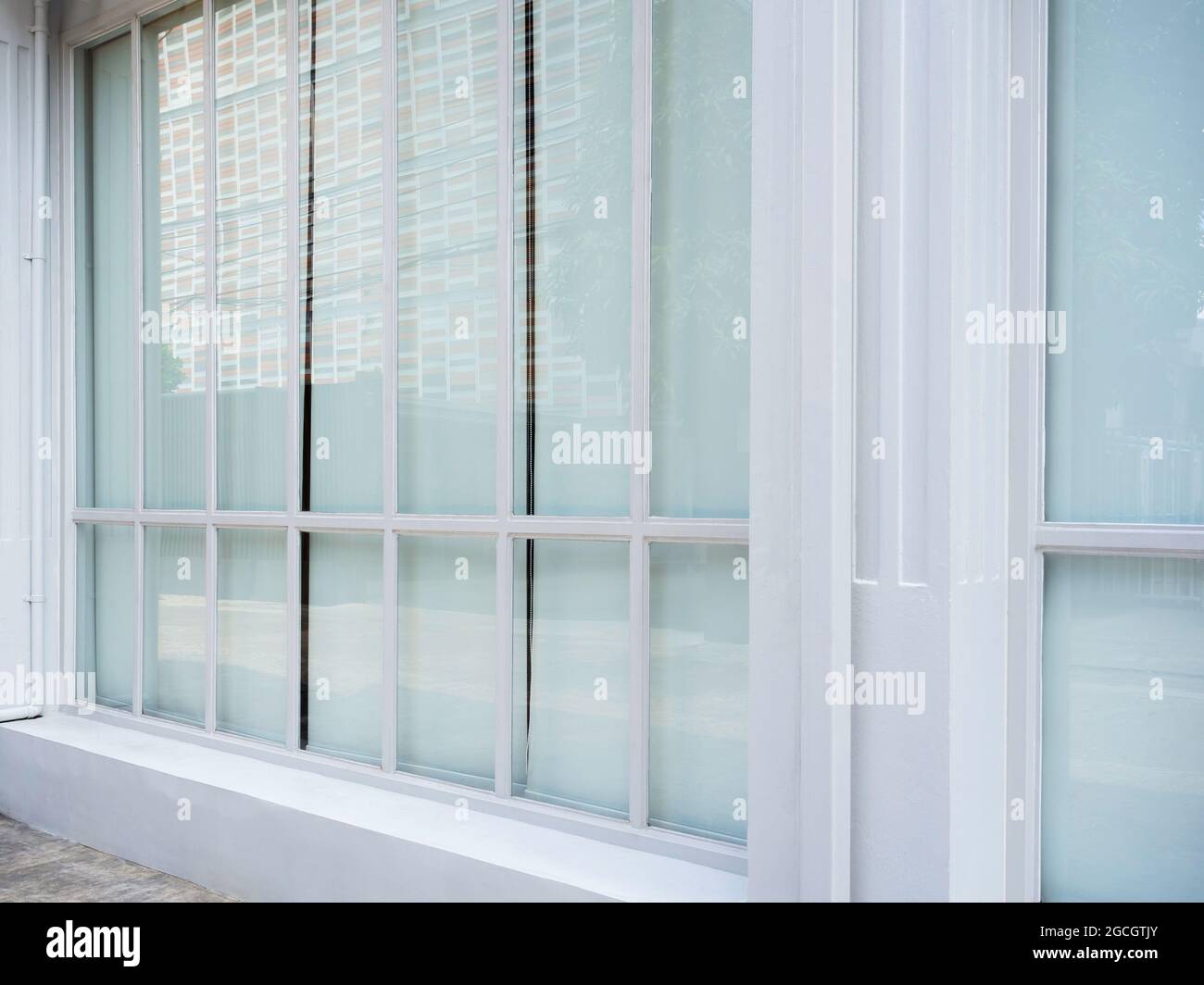 Modern white clean building with tall glass window wall with blinds ...
