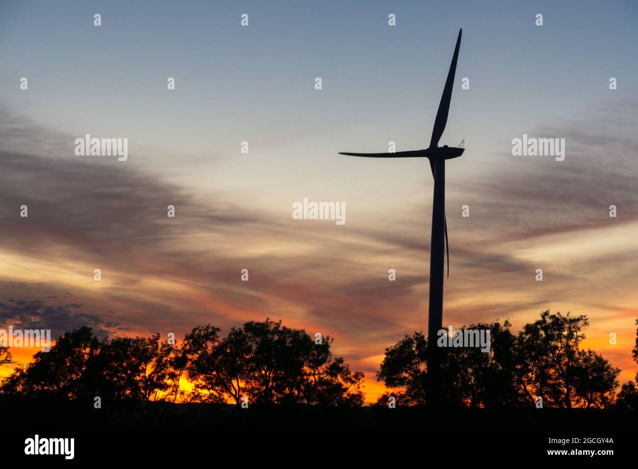 Beautiful exotic sunset sky with wind turbine Stock Photo - Alamy
