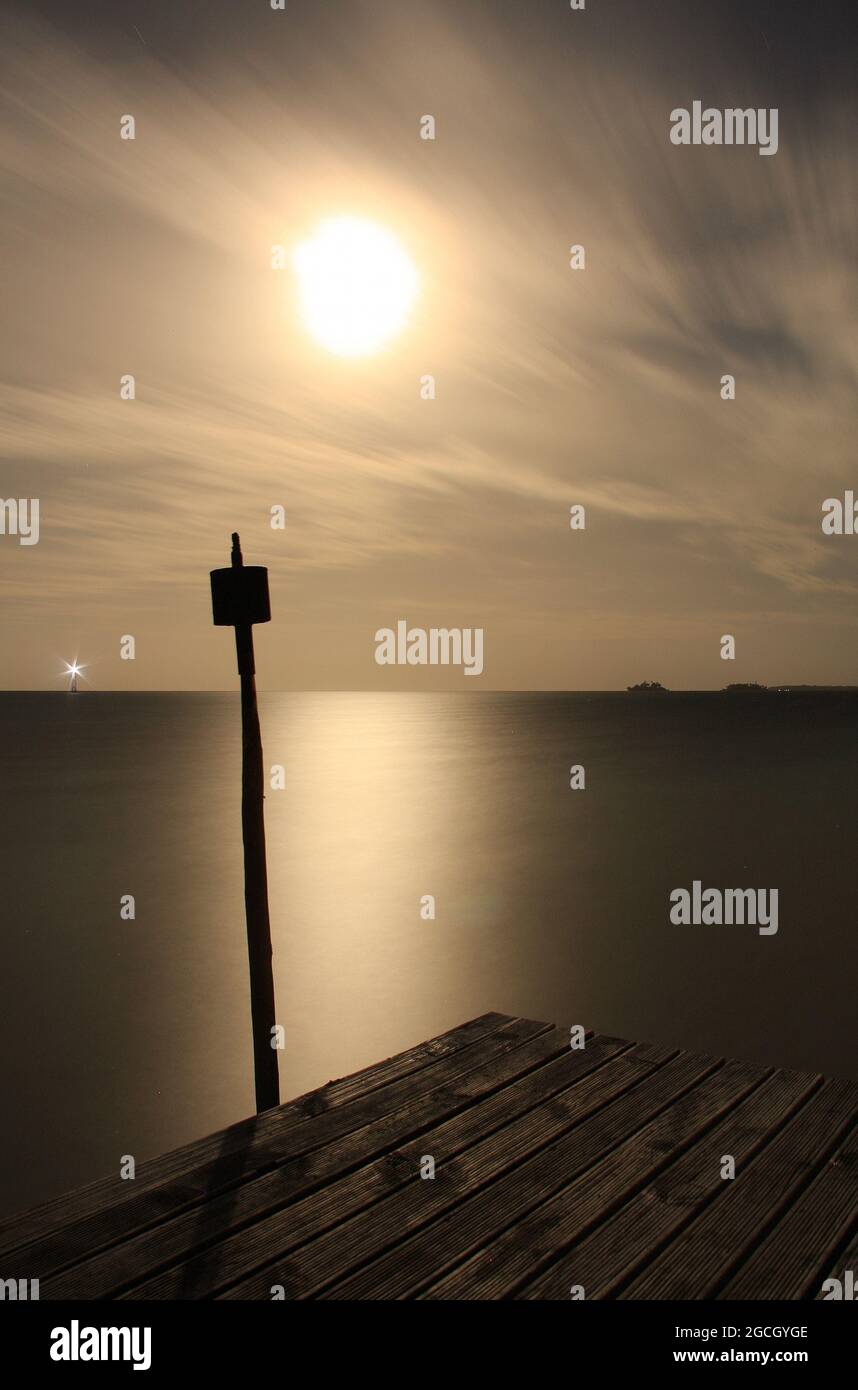long exposure moon at night from pier in tonga Stock Photo - Alamy