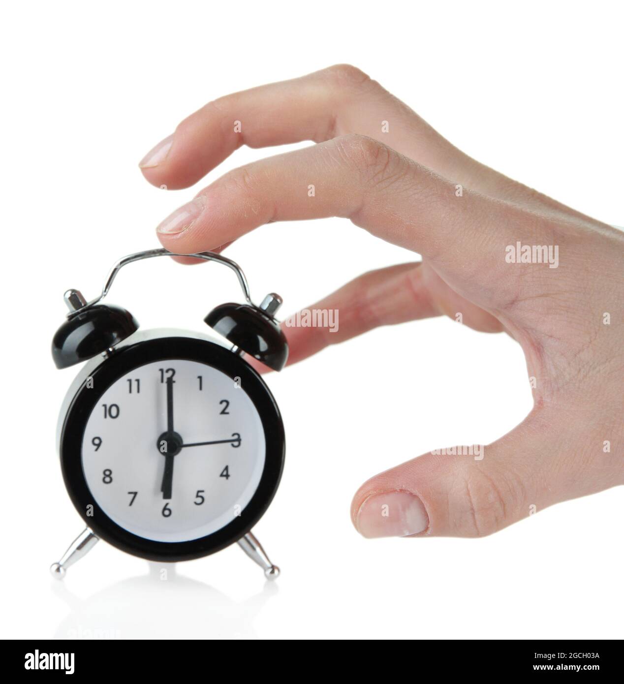 Alarm clock and hand isolated on white Stock Photo - Alamy
