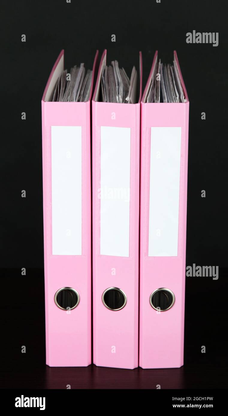 Pink folders on wooden table, on grey background Stock Photo - Alamy
