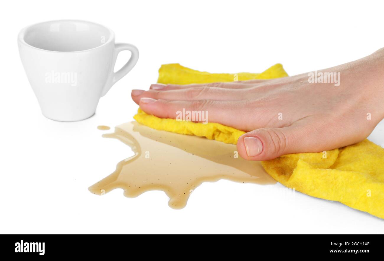 Hand wiping surface with yellow rag and cup of coffee isolated on white ...