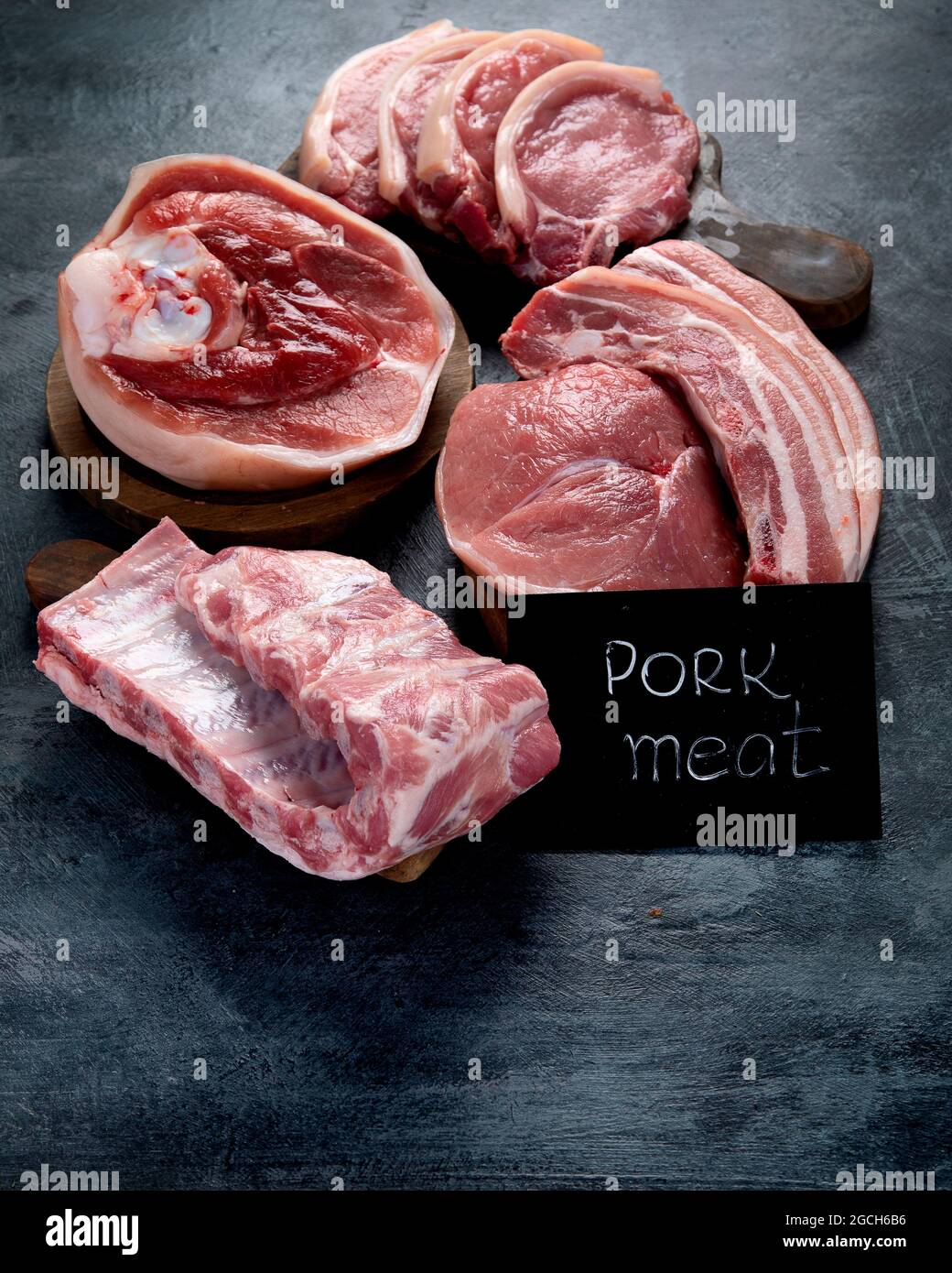 Different types of raw pork meat on black background. Foods high in ...