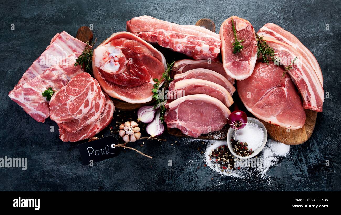 Different types of raw meat on black background. Foods high in protein ...