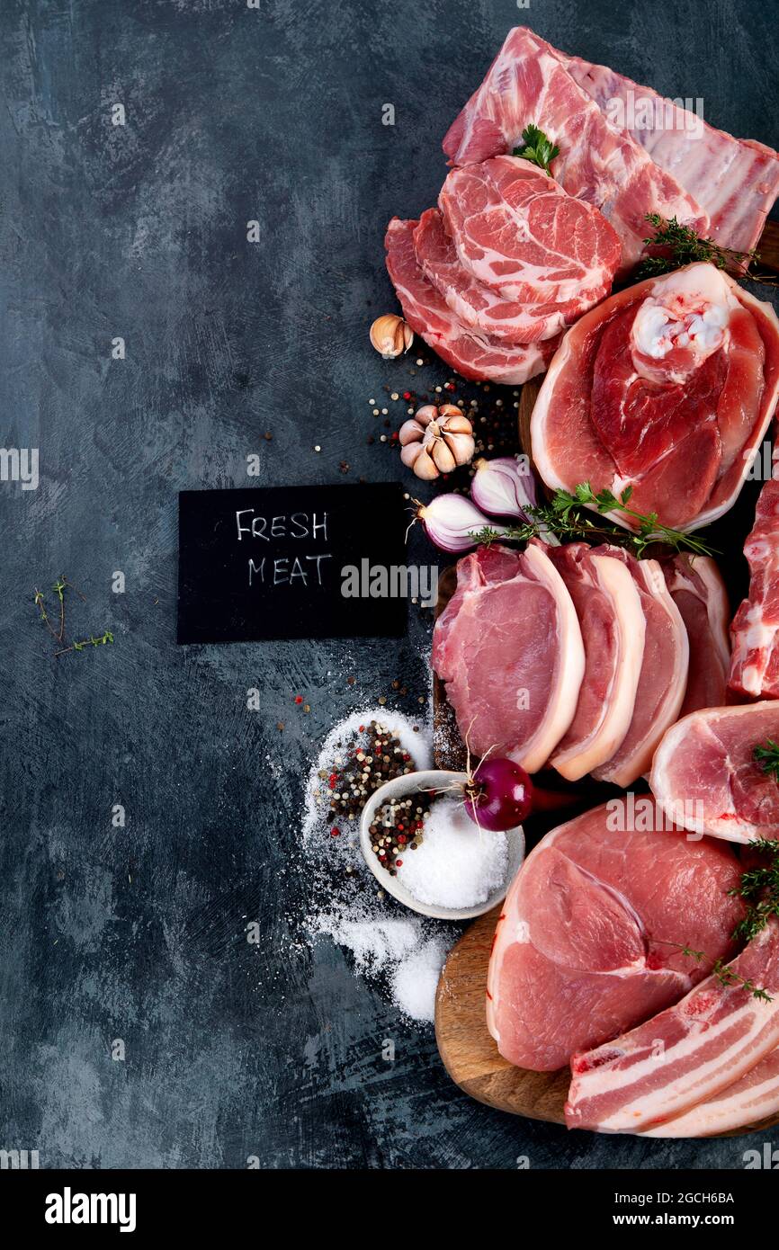 Different types of raw meat on black background. Foods high in protein ...