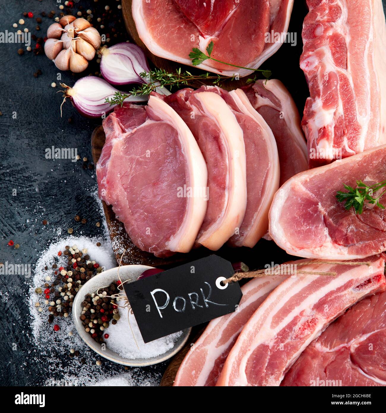 Different types of raw meat on black background. Foods high in protein ...