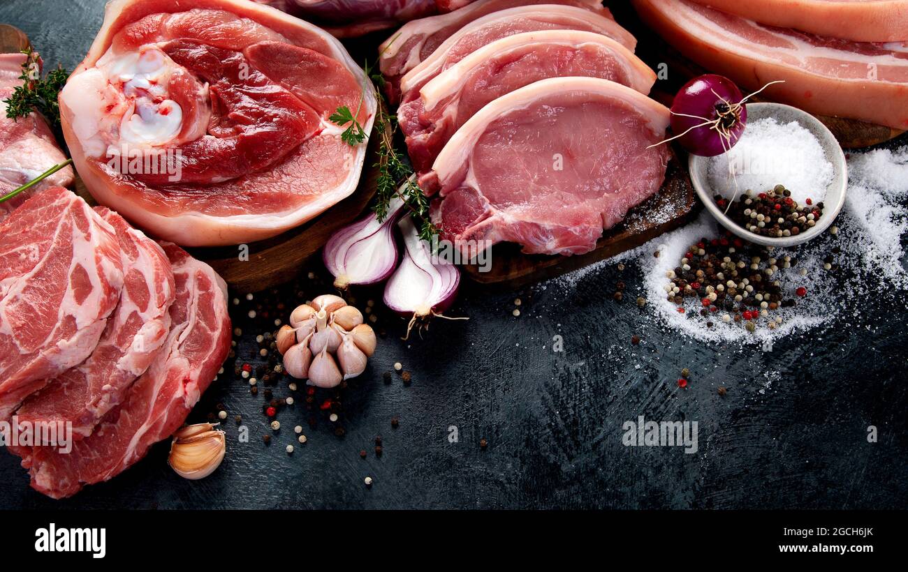 Different types of raw meat on black background. Foods high in protein ...