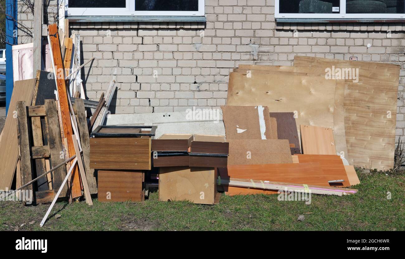 Old broken furniture at the garbage dump near the apartment building ...