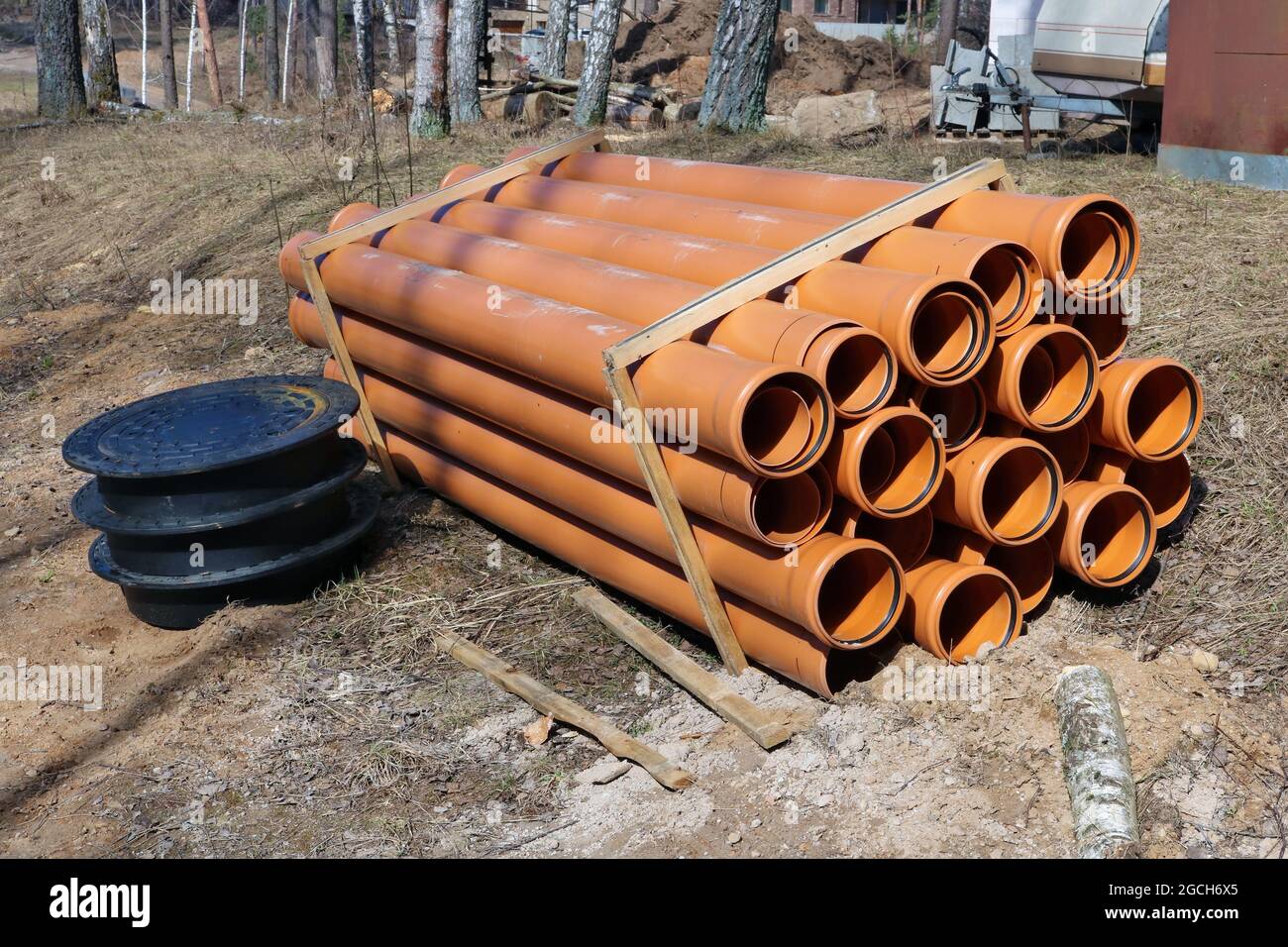 Stack of new plastic drainage pipes at construction site Stock Photo ...