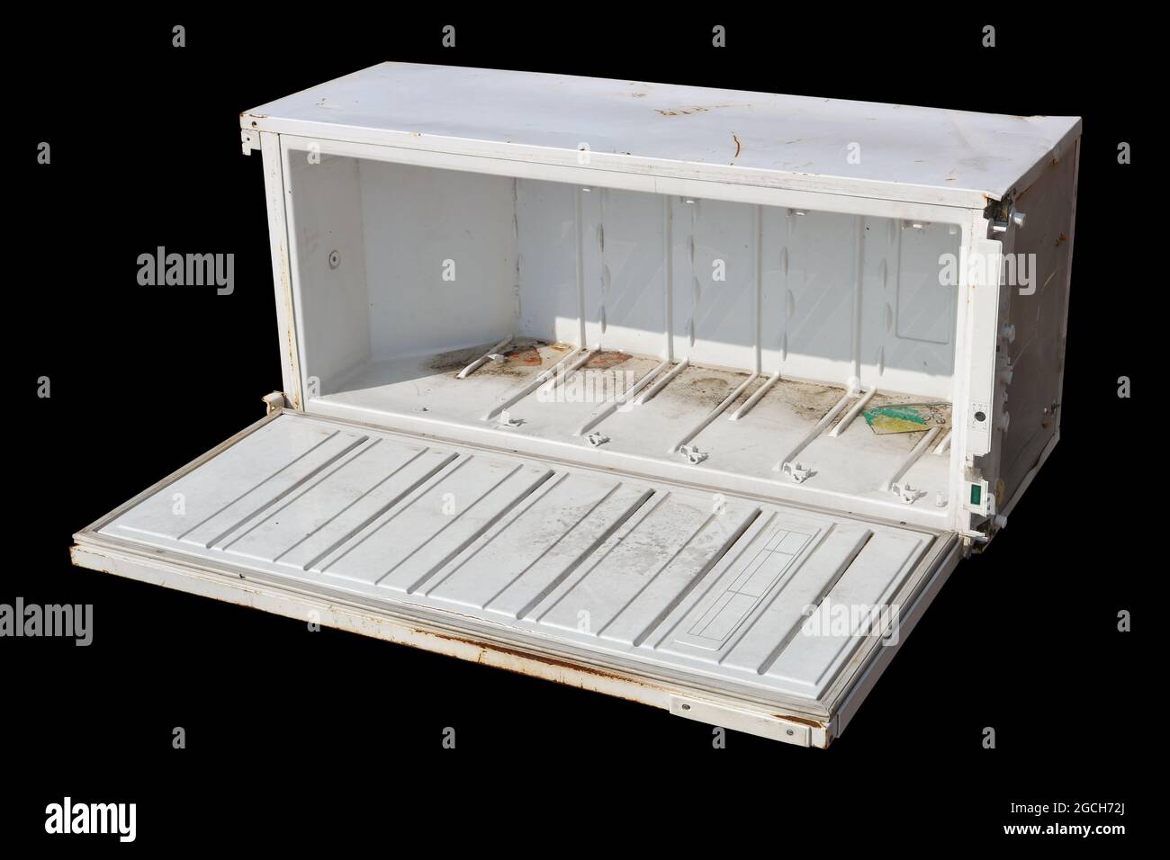 Broken old refrigerator in a garbage dump isolated on black Stock Photo ...