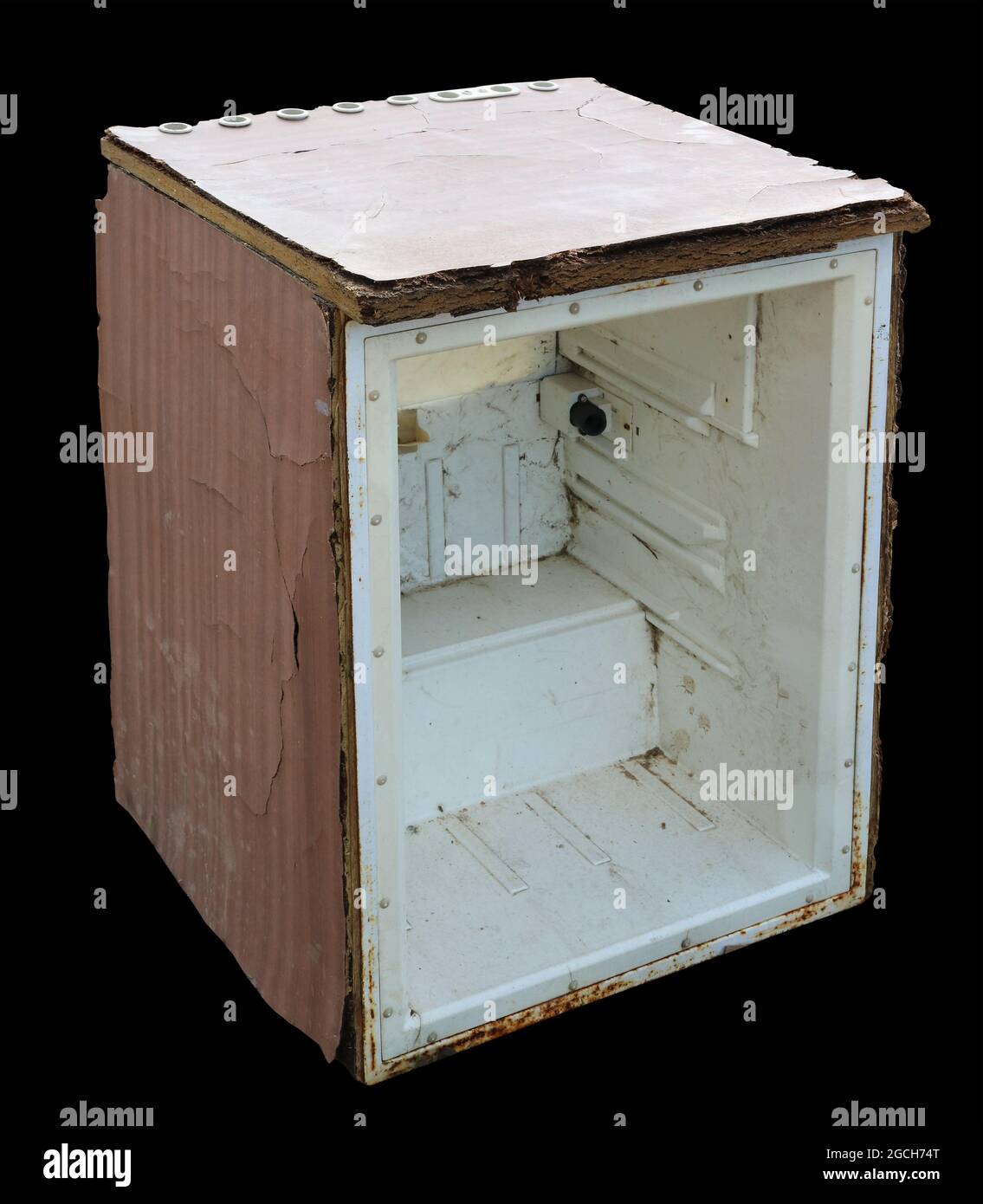 Broken wooden refrigerator in a garbage dump isolated on black Stock ...