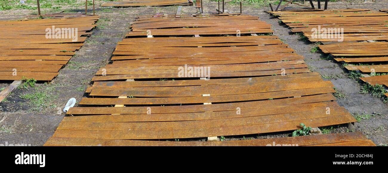 Rusty iron tapes for building a rural fence lie on the ground Stock ...