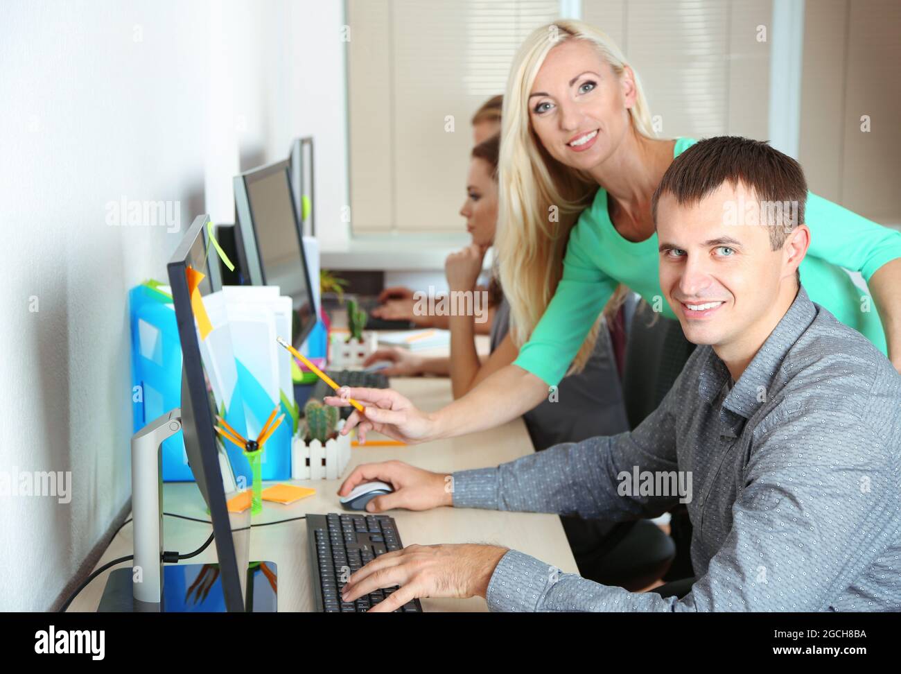 Business people at work place Stock Photo - Alamy