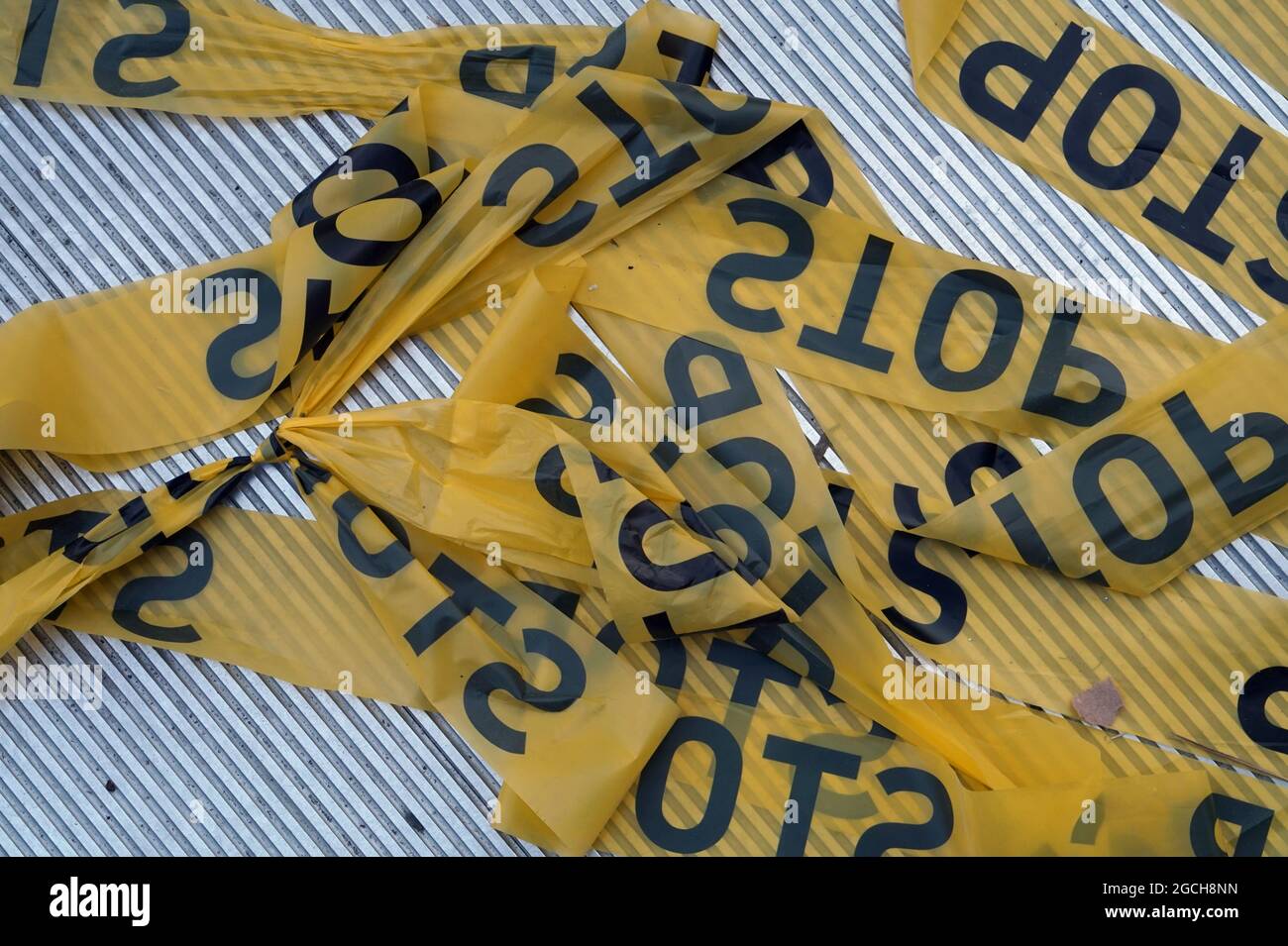 Crumpled yellow stop tape Stock Photo - Alamy