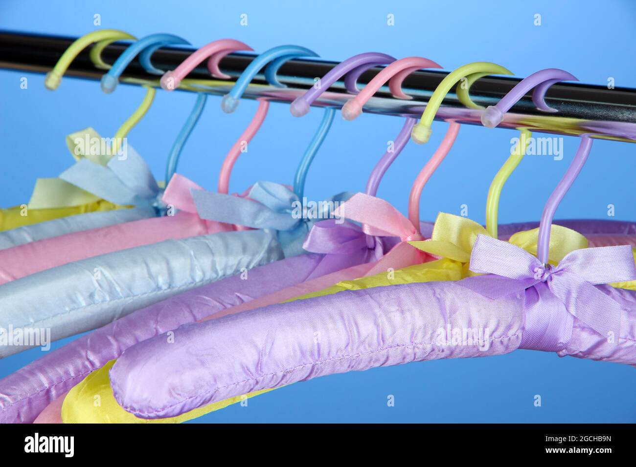 Beautiful hangers on blue background Stock Photo - Alamy