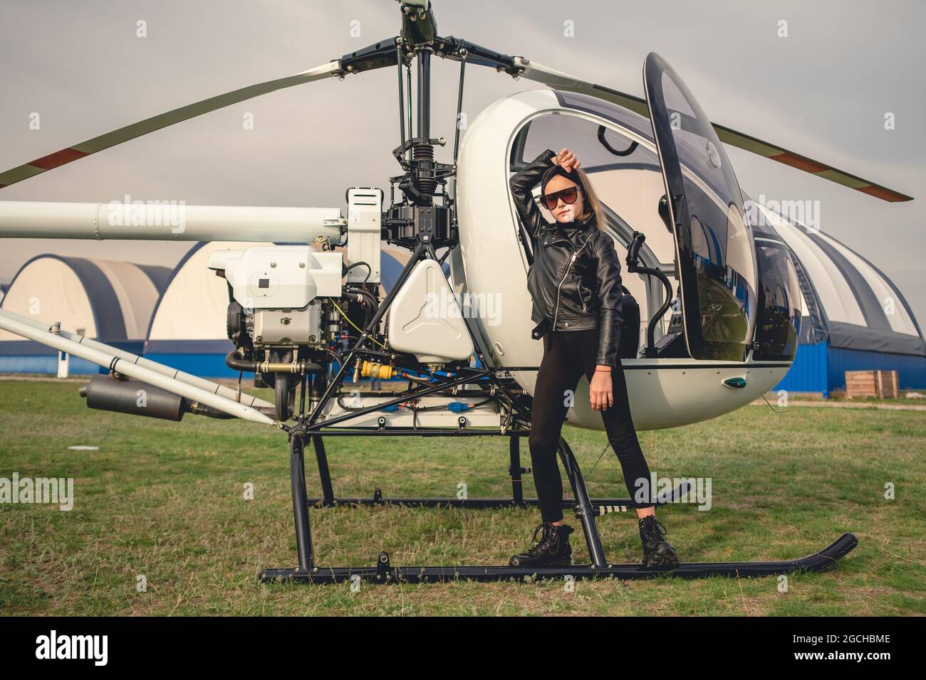 Tween girl in black clothes standing near helicopter Stock Photo - Alamy