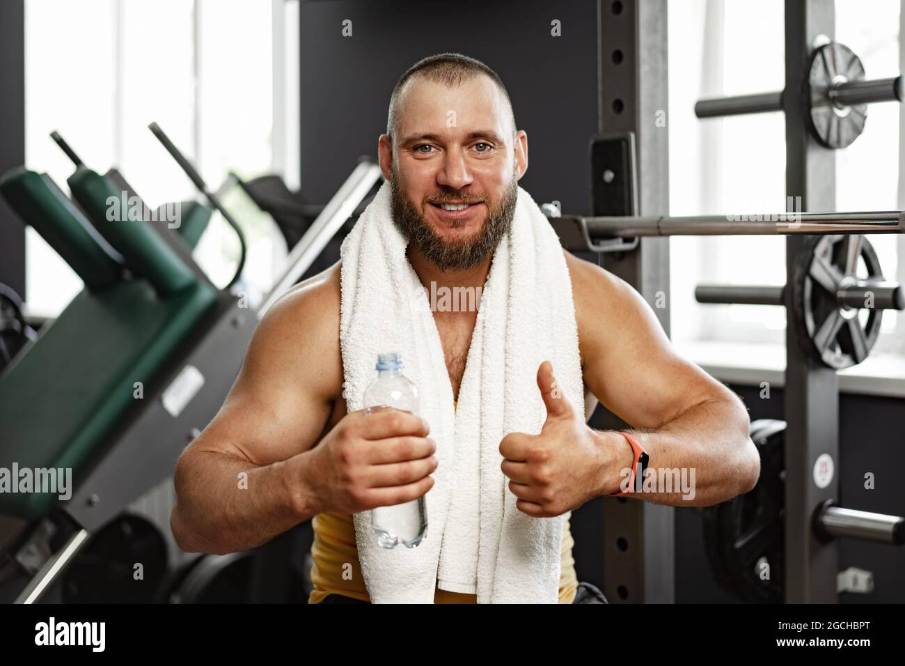 Cheerful smiling man bodybuilder standing in a gym Stock Photo - Alamy