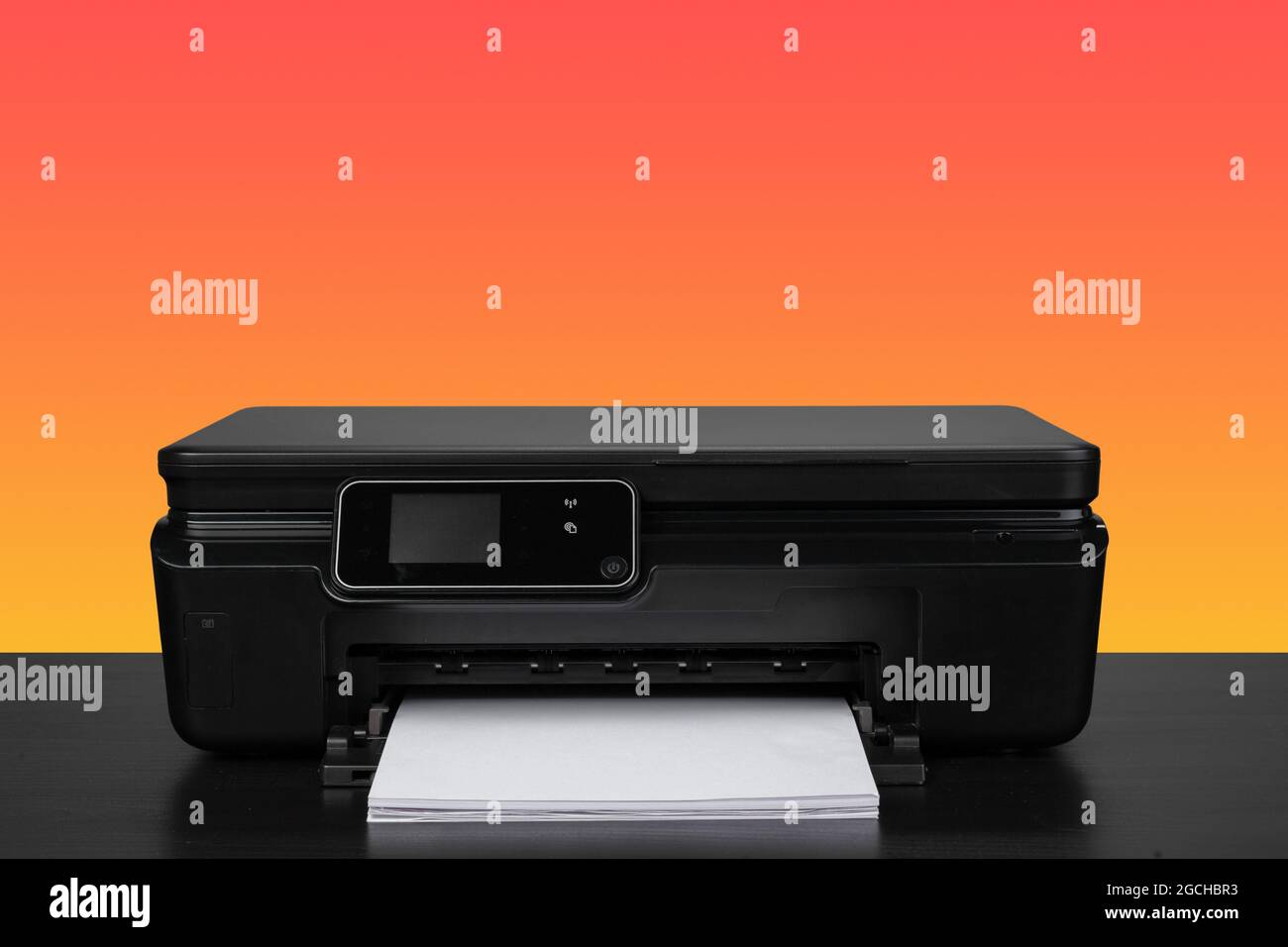 Compact home laser printer against orange background Stock Photo - Alamy