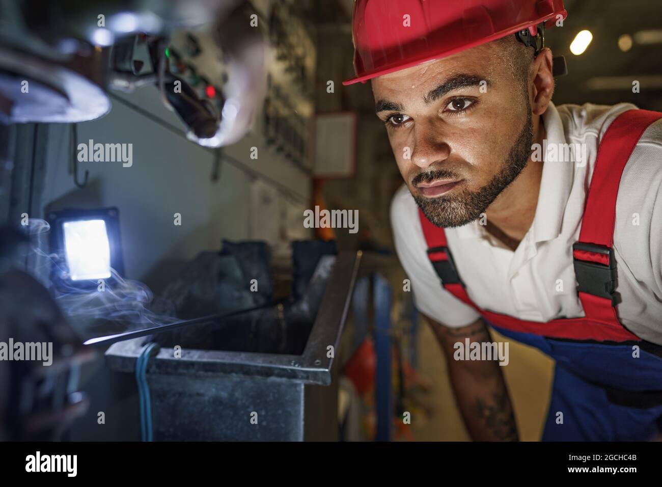 Portrait of african american male handyman working in an industrial ...
