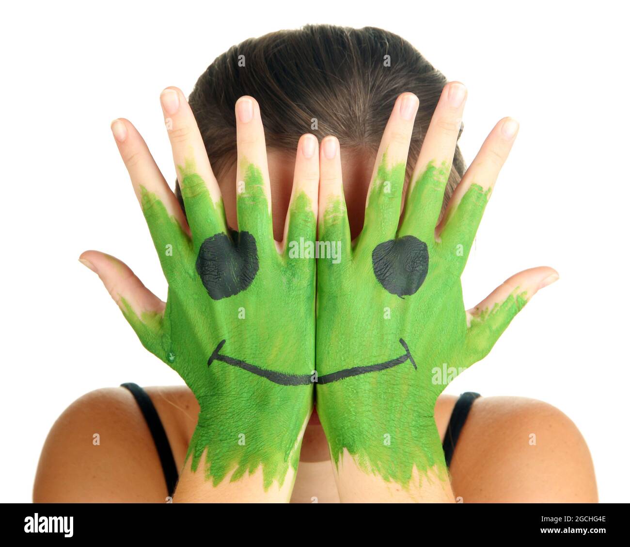 Portrait of girl hiding her face under smile mask isolated on white ...