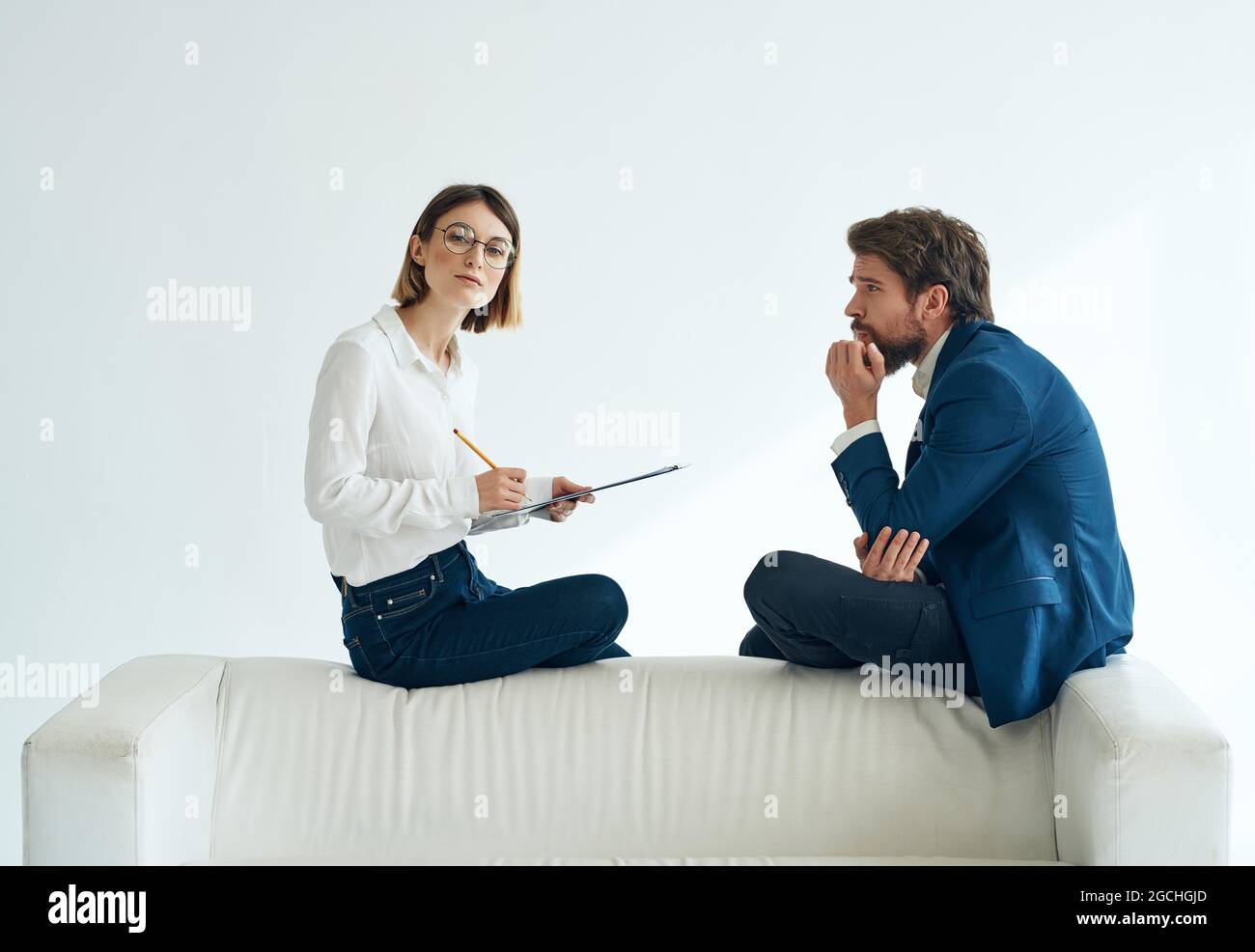 man and woman communication white sofa emotions team documents Stock ...