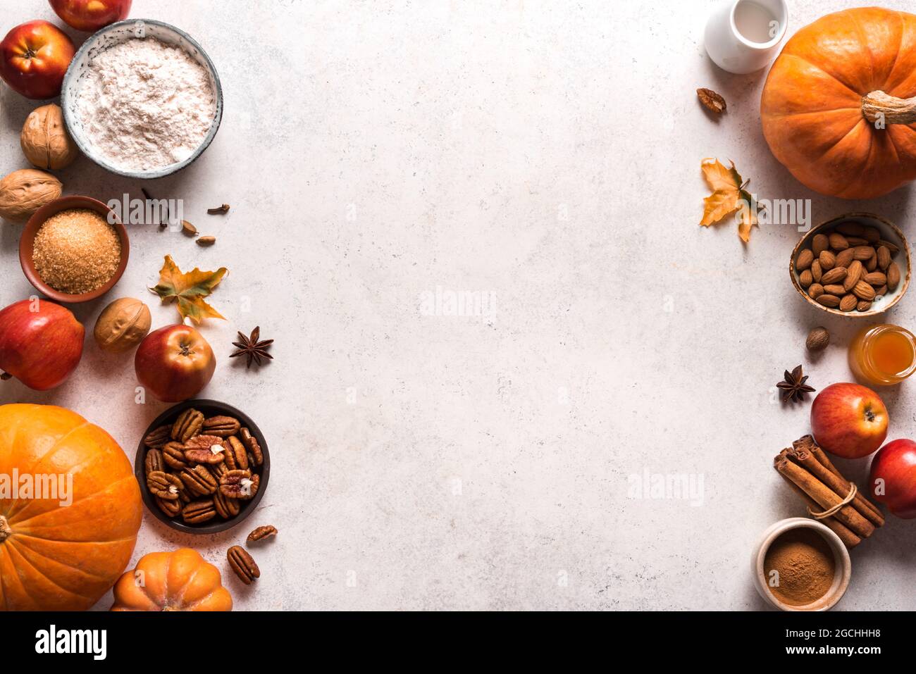Autumn fall baking food background with pumpkins, apples, nuts and ...