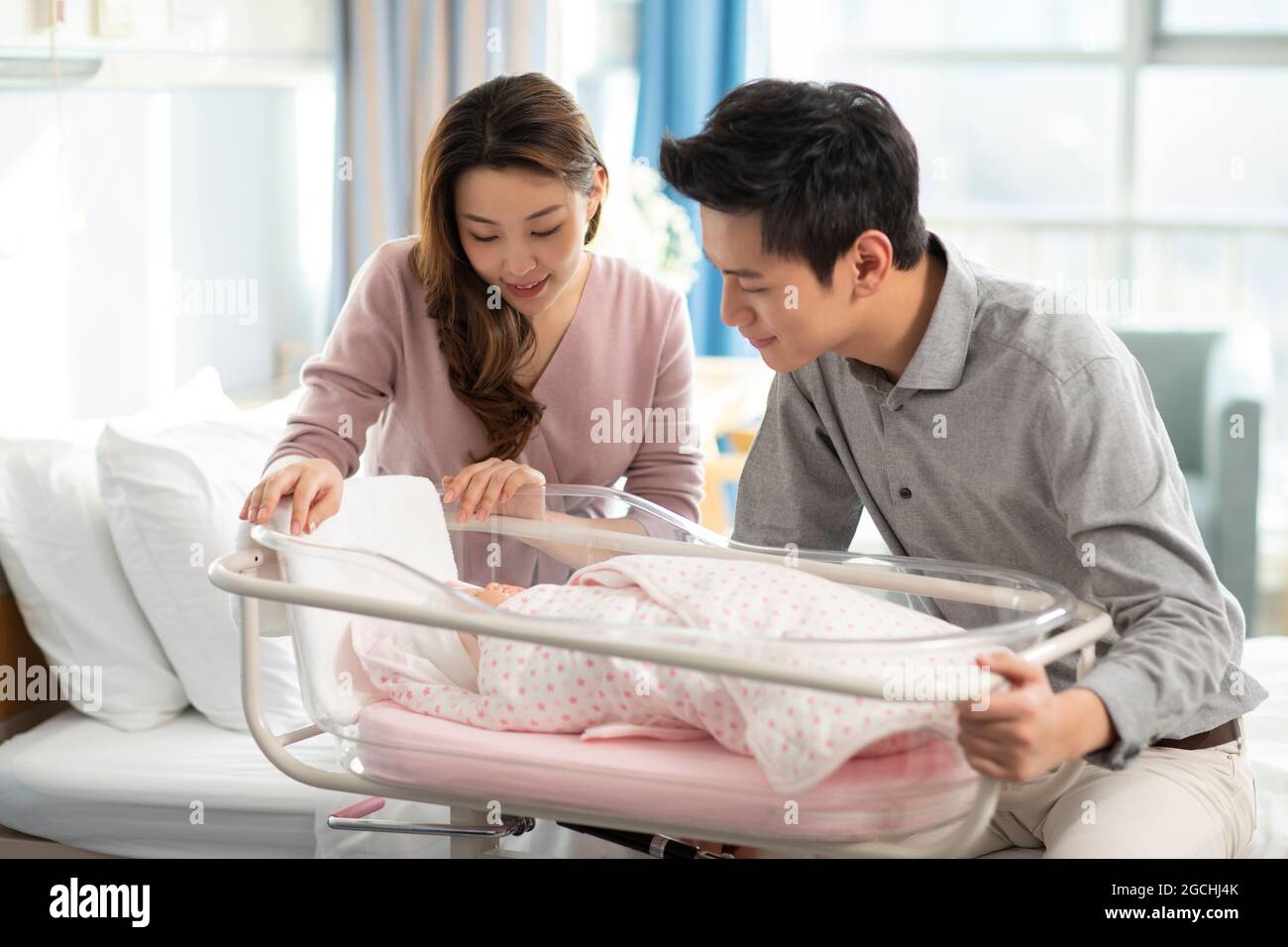 Parents with newborn baby in hospital ward Stock Photo - Alamy
