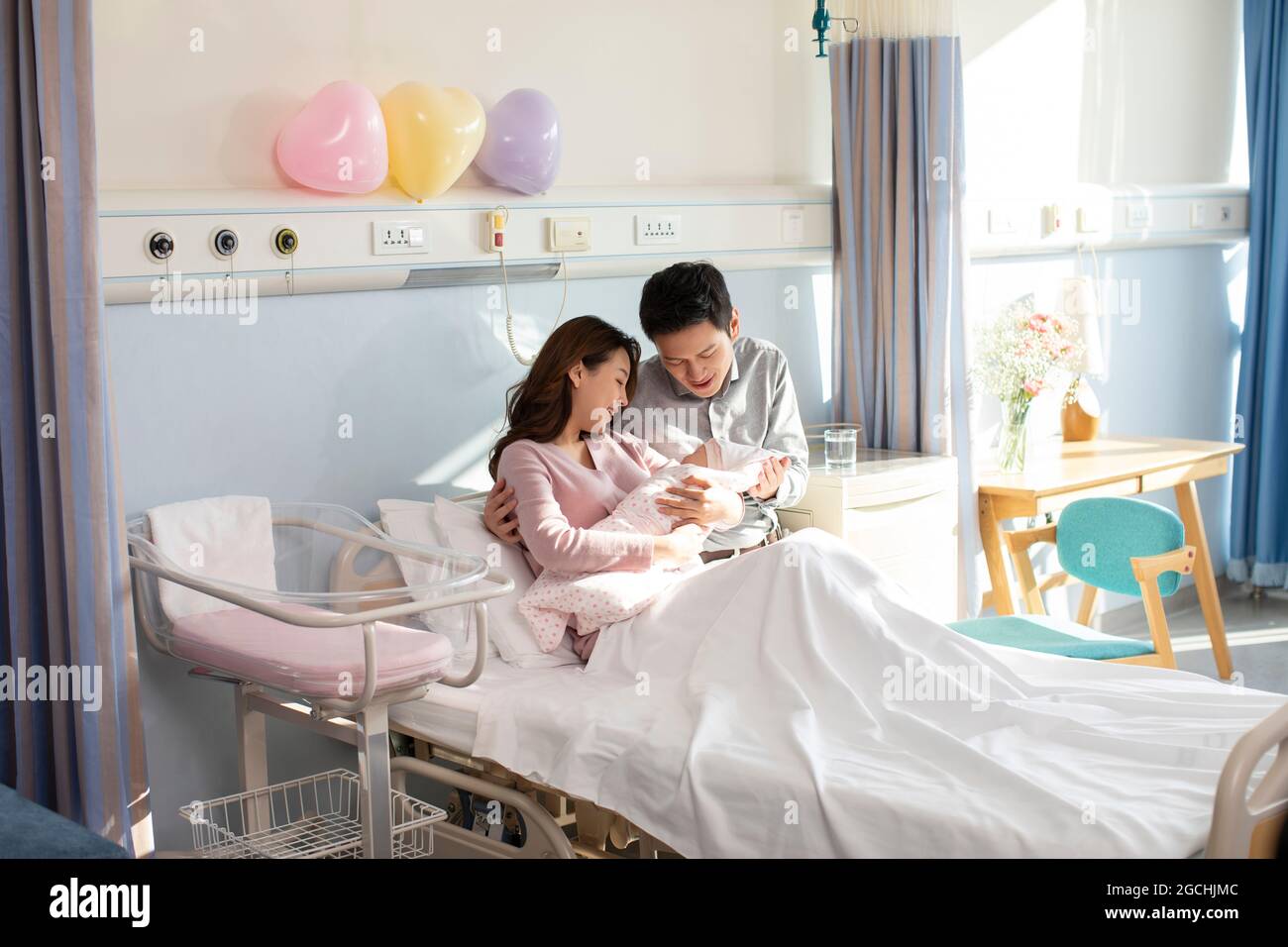 Parents with newborn baby in hospital ward Stock Photo - Alamy