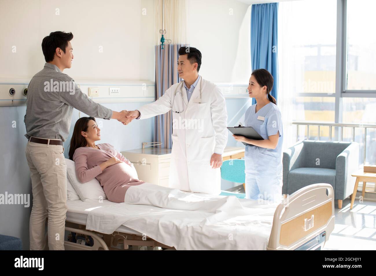 Doctor examining pregnant woman in hospital ward Stock Photo - Alamy